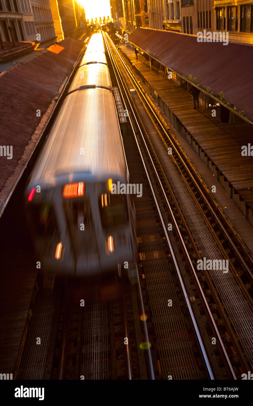 Sunrise illuminates a train in the Chicago rapid transit system known ...