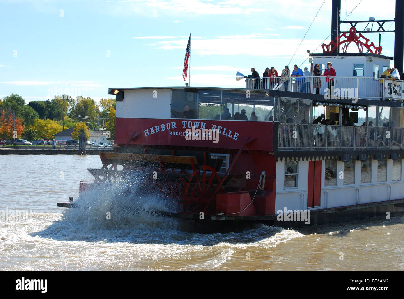 Tourists take paddle boat ride on the Harbor Town Belle up the Genesee ...
