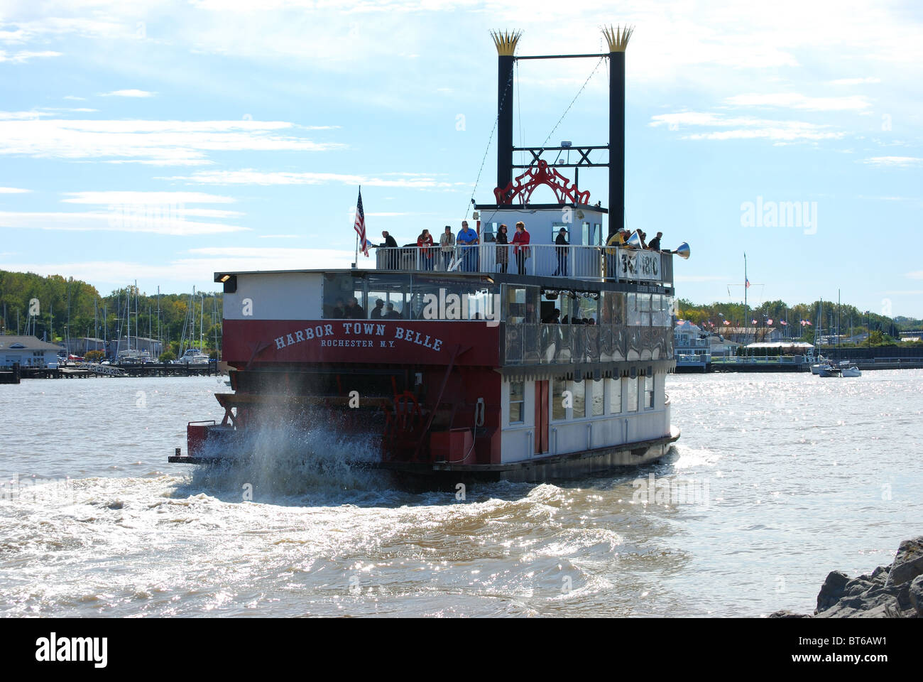 Tourists take paddle boat ride on the Harbor Town Belle up the Genesee ...