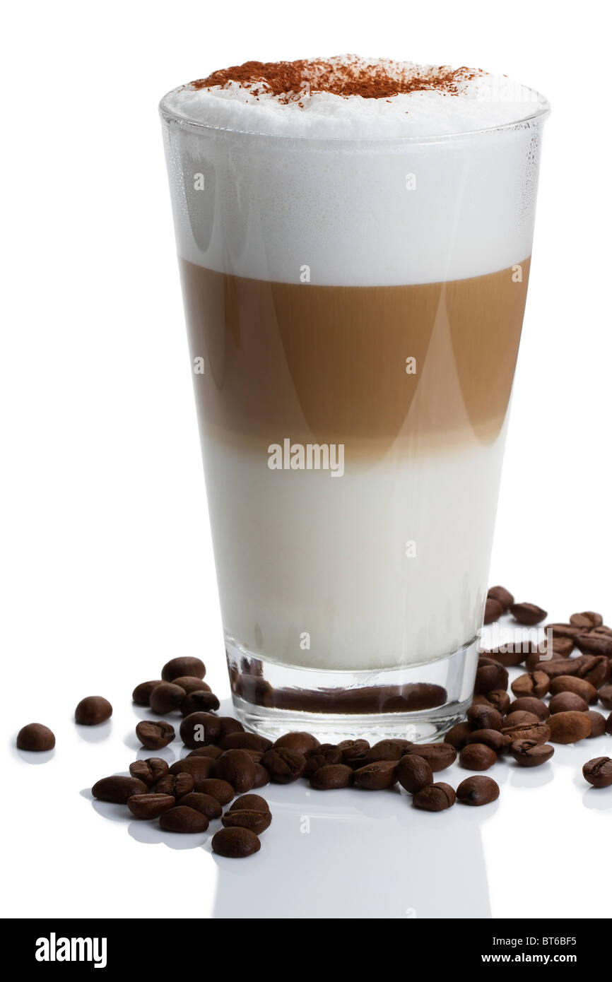 latte macchiato with cocoa powder and coffee beans on white background ...