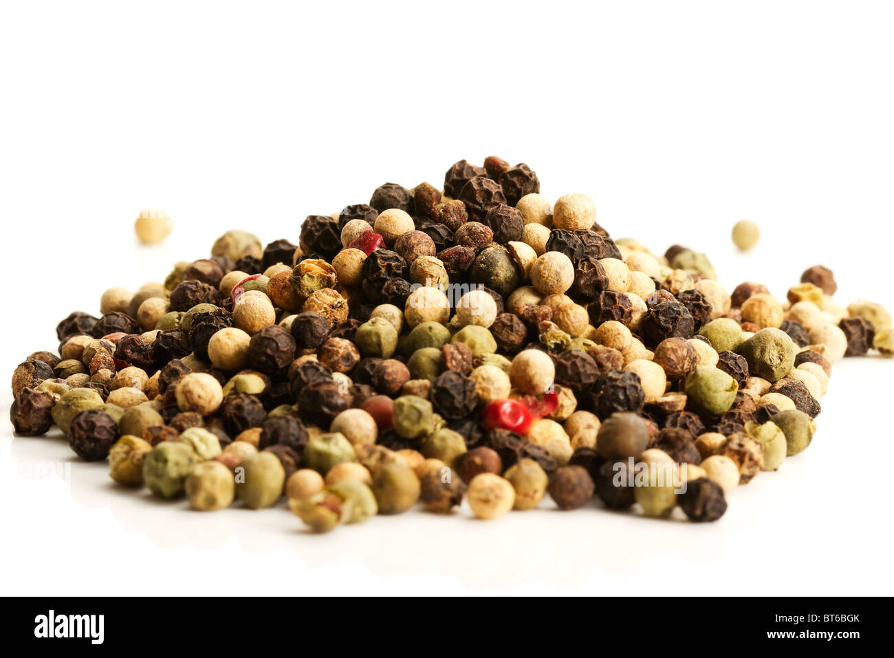 a lot of mixed peppercorns on white background Stock Photo - Alamy