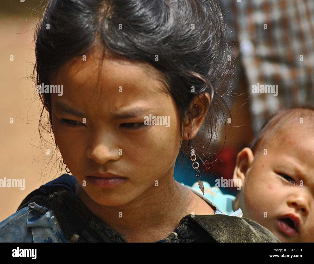Indigenous girl carrying baby near Sapa, Vietnam Stock Photo - Alamy
