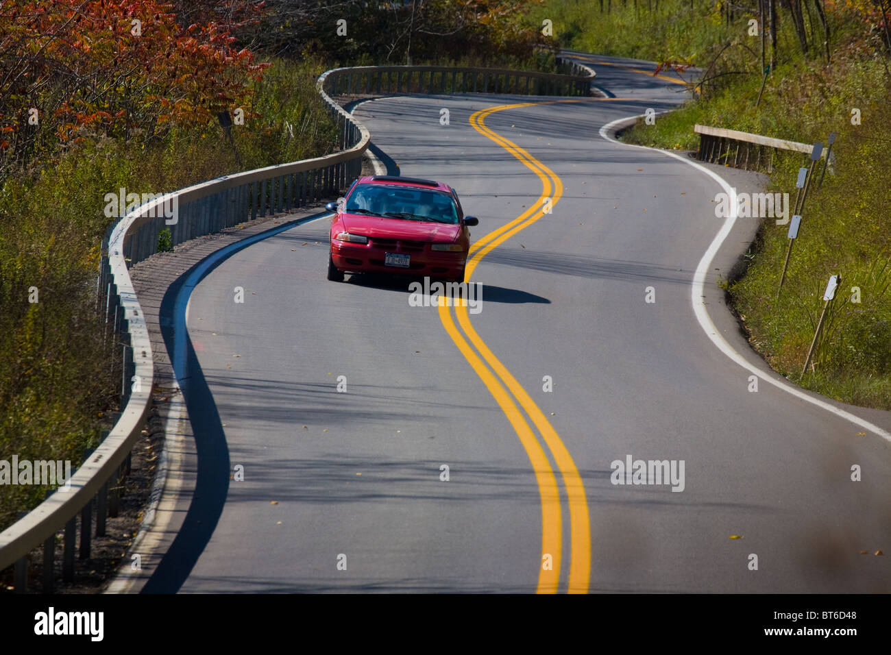 Car on a winding road upstate New York Stock Photo - Alamy