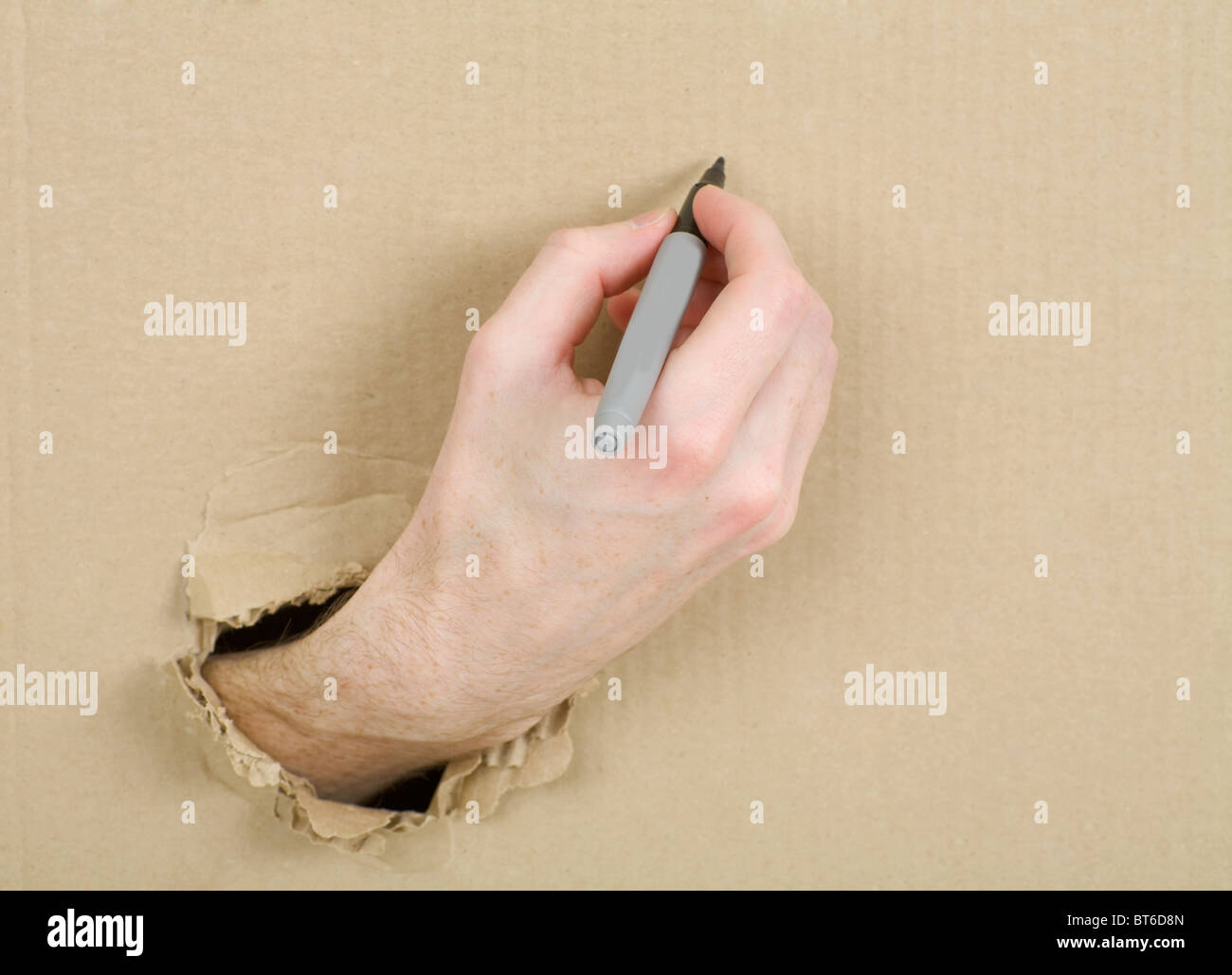 Hand with marker written on cardboard sheet Stock Photo - Alamy