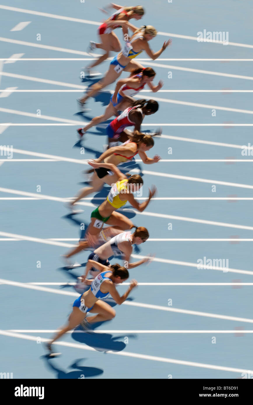 female sprinters running on blue track in womens race Stock Photo - Alamy