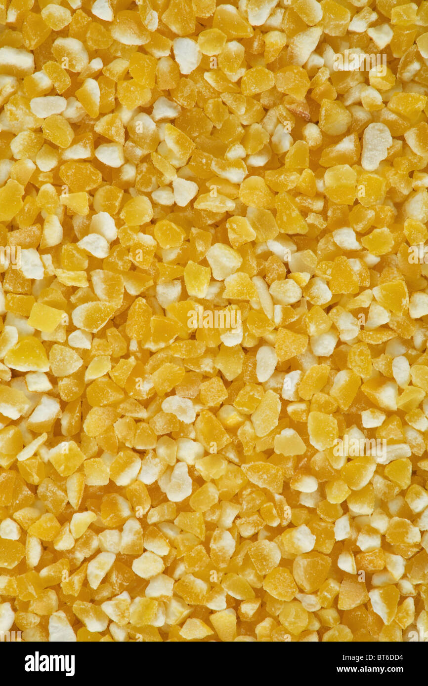 Yellow crushed maize cereals background close up Stock Photo - Alamy