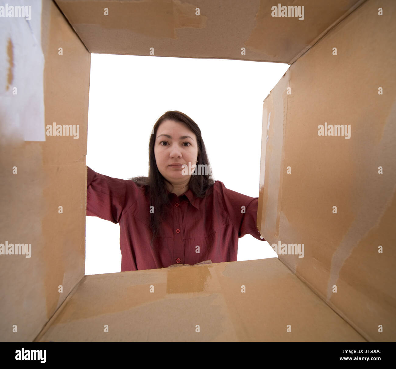 Female face looking through cardboard box on white Stock Photo - Alamy