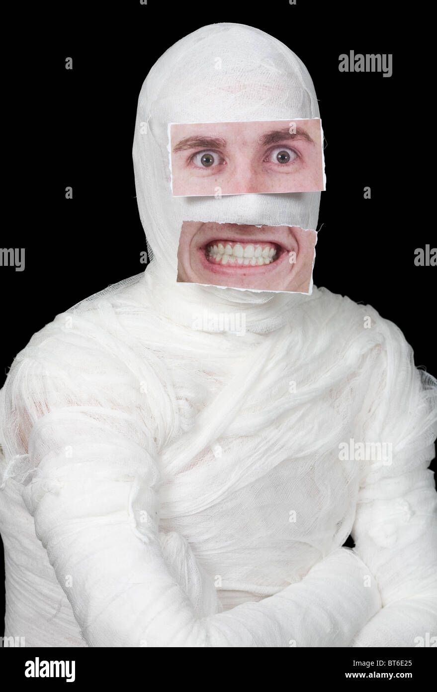 Bandaged man with false paper face on black Stock Photo - Alamy
