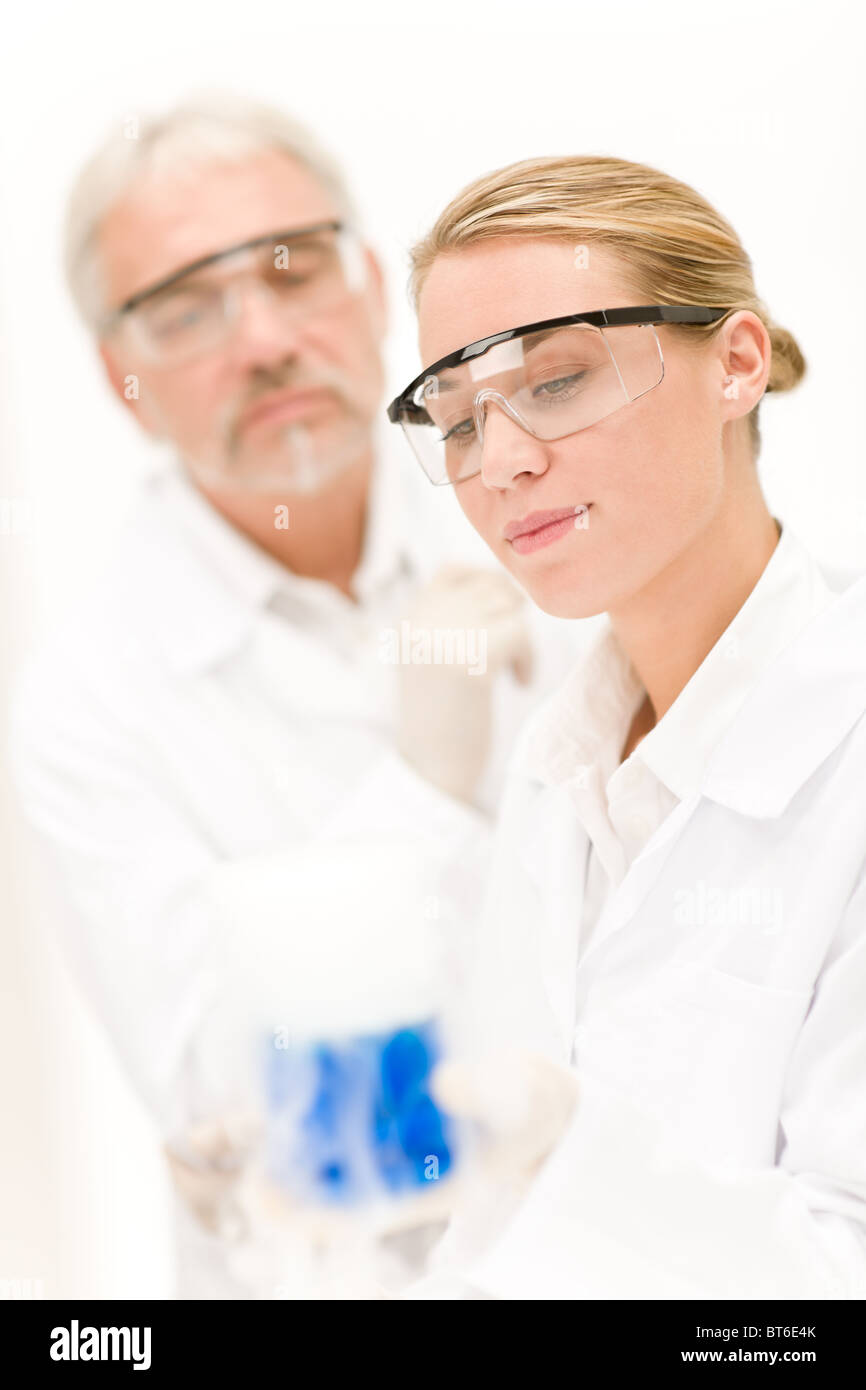 Chemistry experiment - scientists in laboratory, wear protective ...