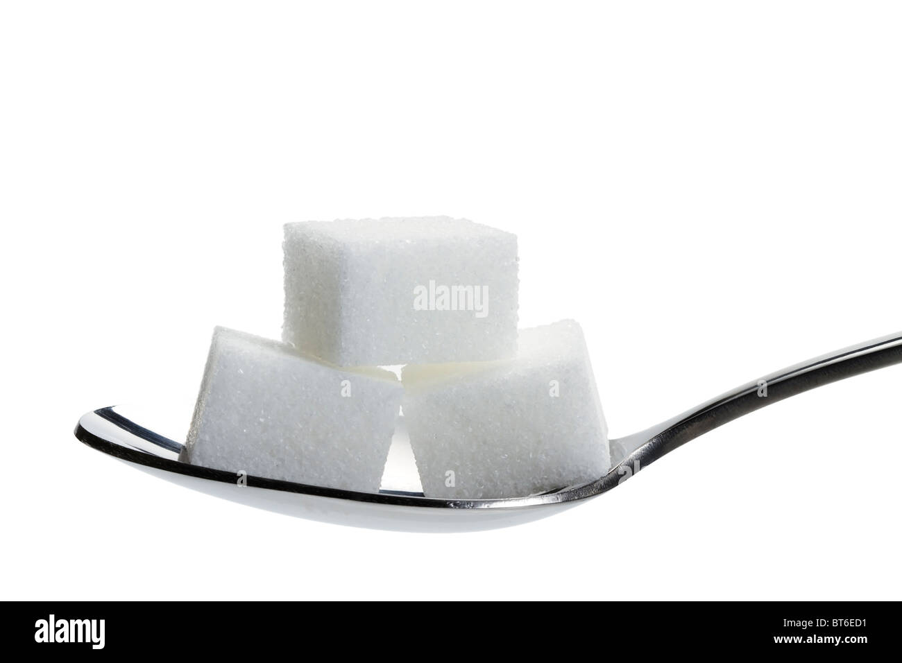 three lump sugar on a spoon isolated on white background Stock Photo ...