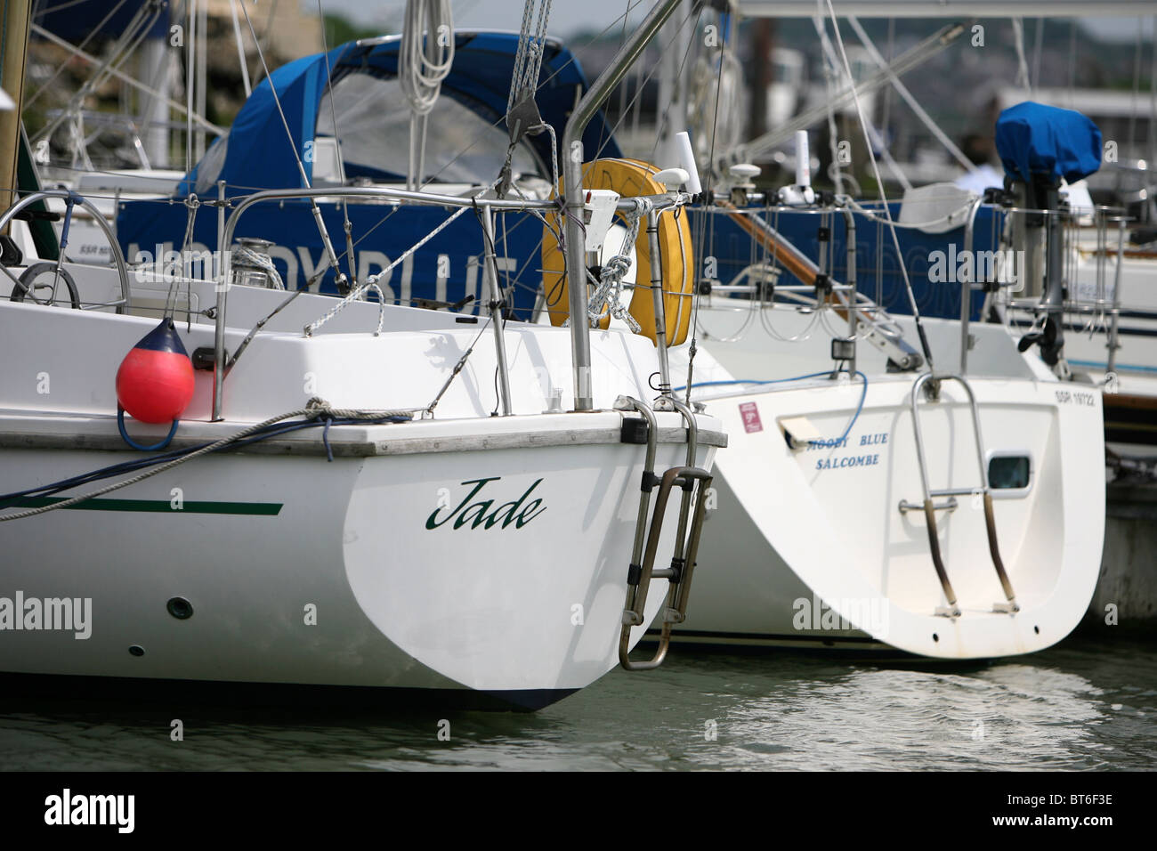 The stern of two yachts in a harbour Stock Photo - Alamy