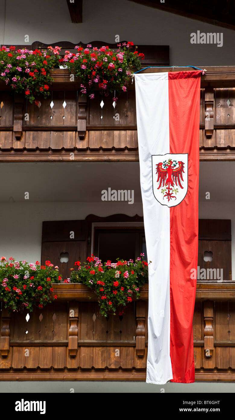 Tyrol state flag deployed on a house front, St Antom am Arlberg ...