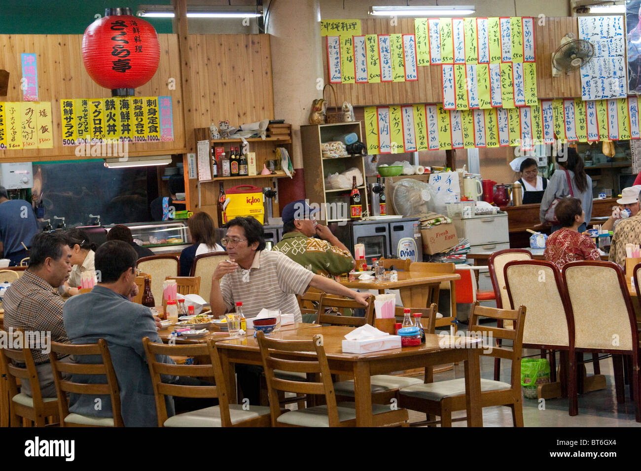 Three Japanese men eat at a restaurant in the Makishi Market in Naha ...
