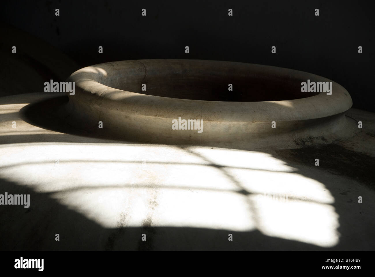 Clay container with hole inside a warehouse Stock Photo - Alamy