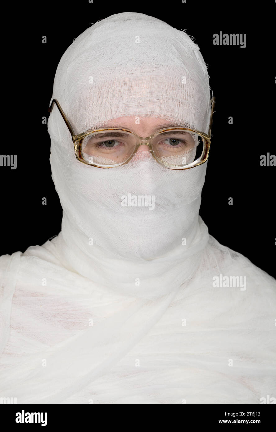 Sorrowful bandaged men in spectacles on black background Stock Photo ...