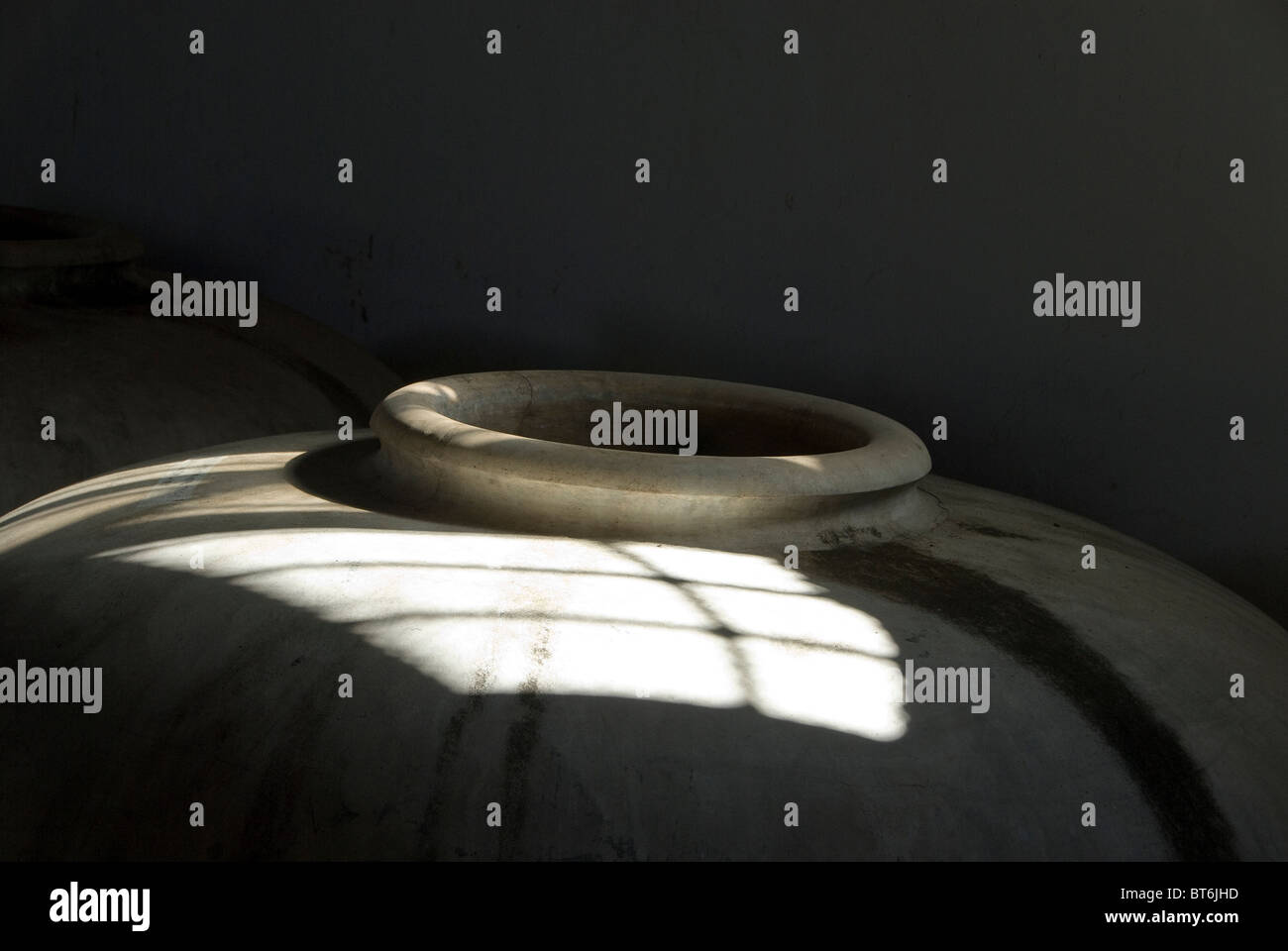 Clay container with hole inside a warehouse Stock Photo - Alamy