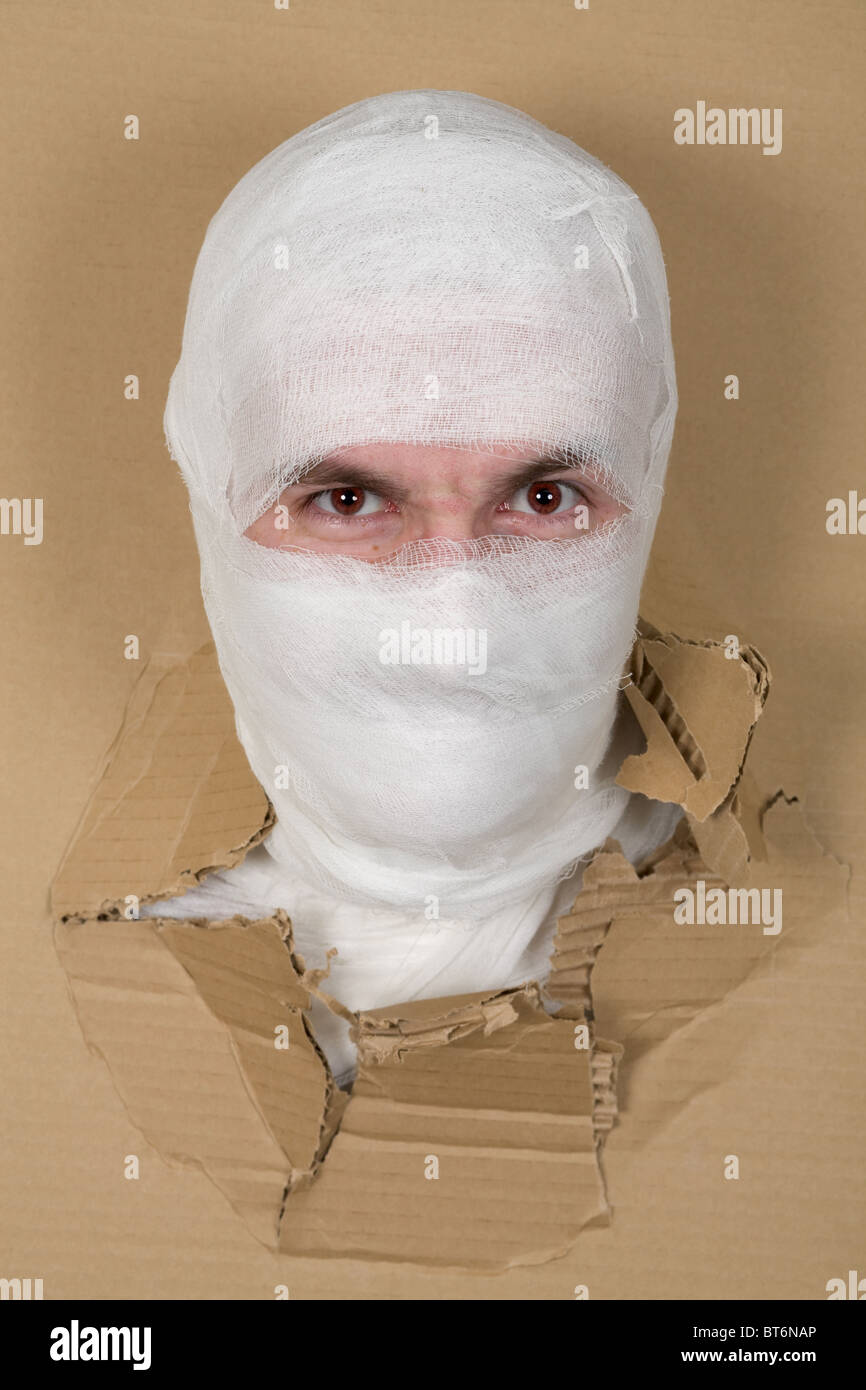 Mummy with angry face braking through the hole in cardboard Stock Photo ...