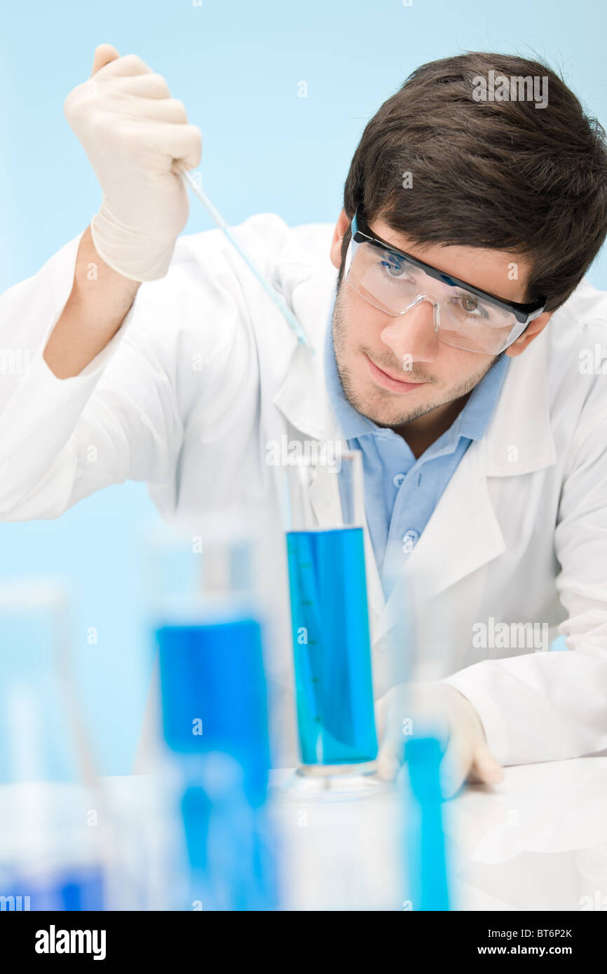 Chemistry experiment - scientist in laboratory, wear protective eye ...
