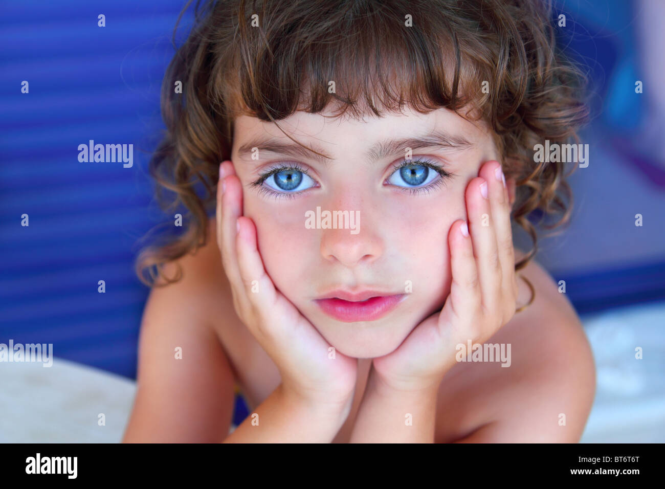 Beautiful blue eyes serene little girl portrait hands on face Stock ...