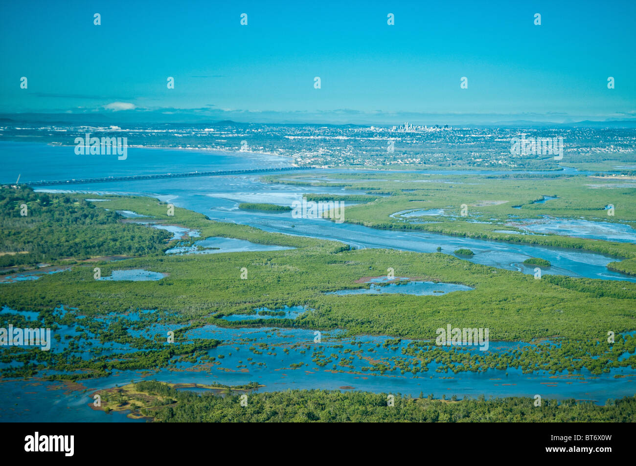 Aerial view of Hays Inlet Conservation Park (fg), Brisbane city in ...