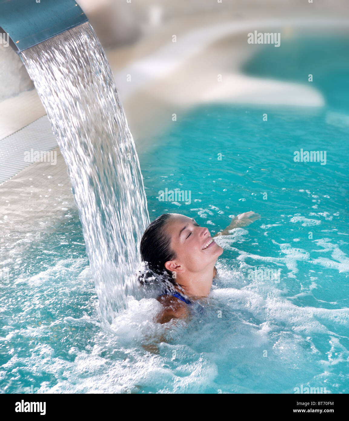 spa hydrotherapy woman waterfall jet turquoise swimming pool water ...