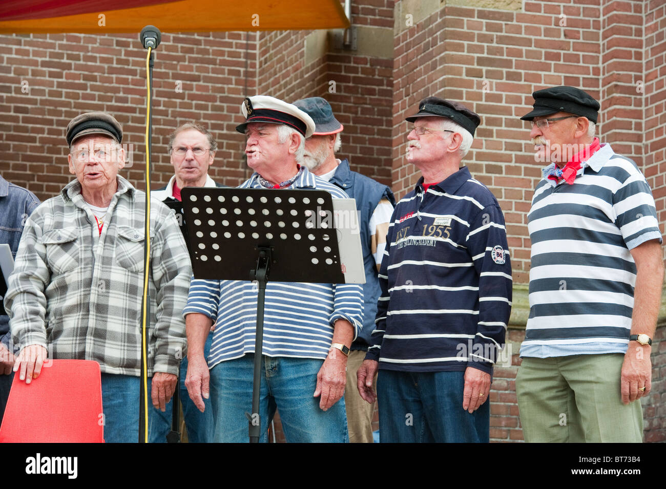 Shanty choir with sailor man singing Stock Photo - Alamy