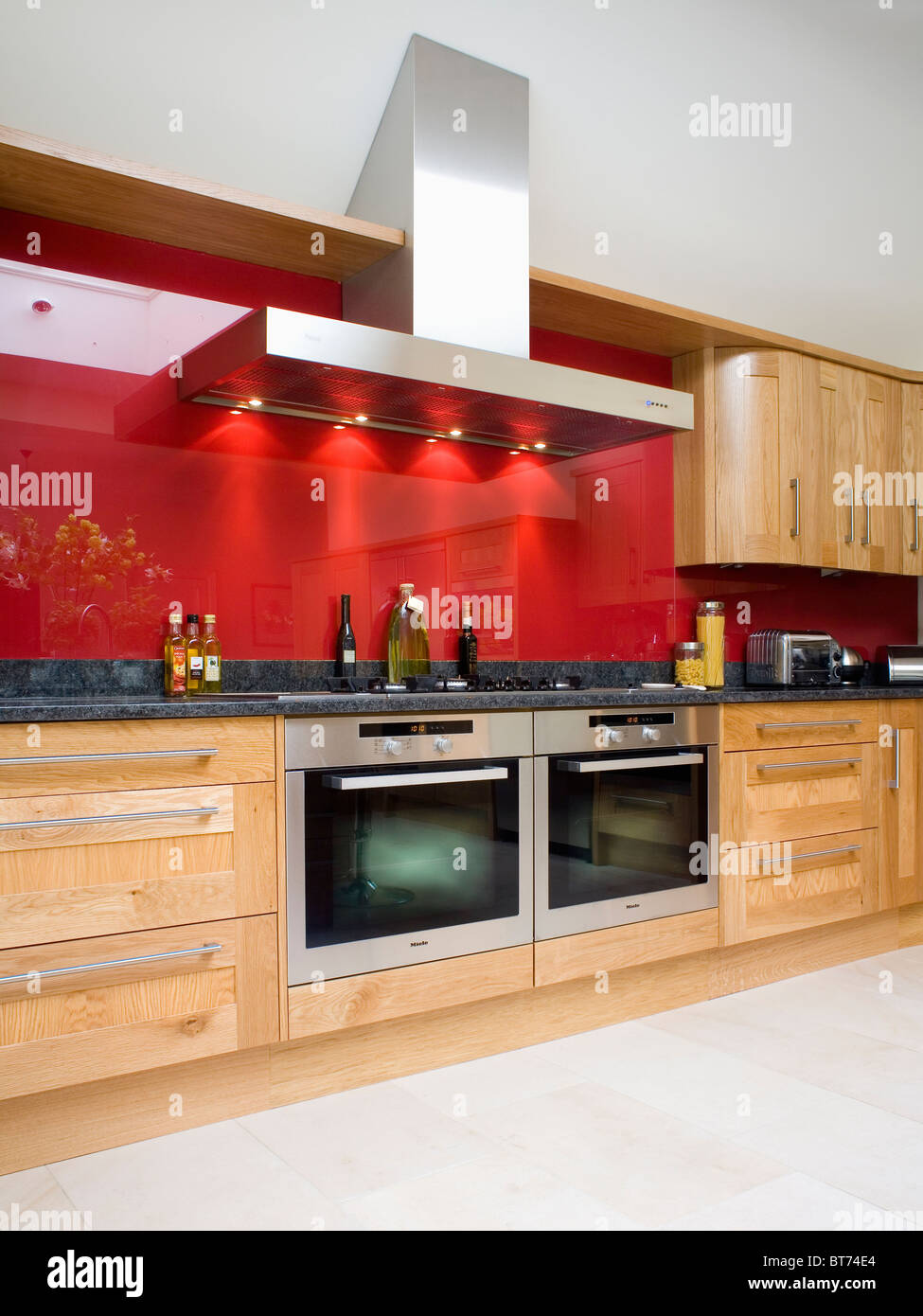 Large stainless-steel extractor with integral lighting above double ...