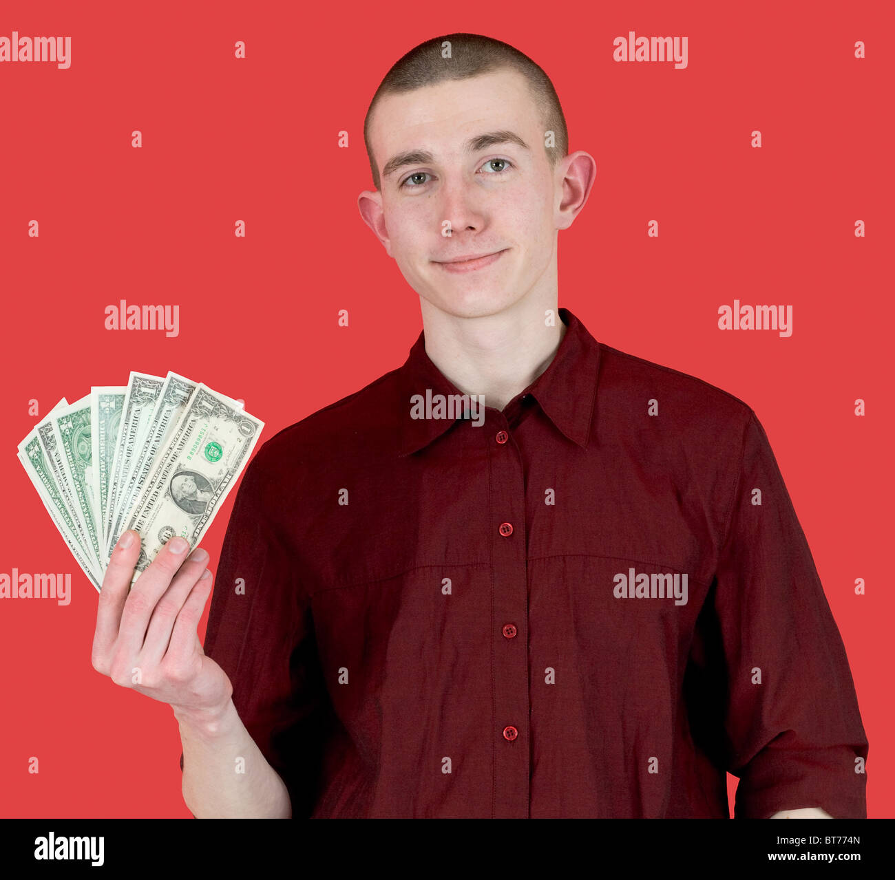 Young man with pack of dollars on his hand Stock Photo - Alamy