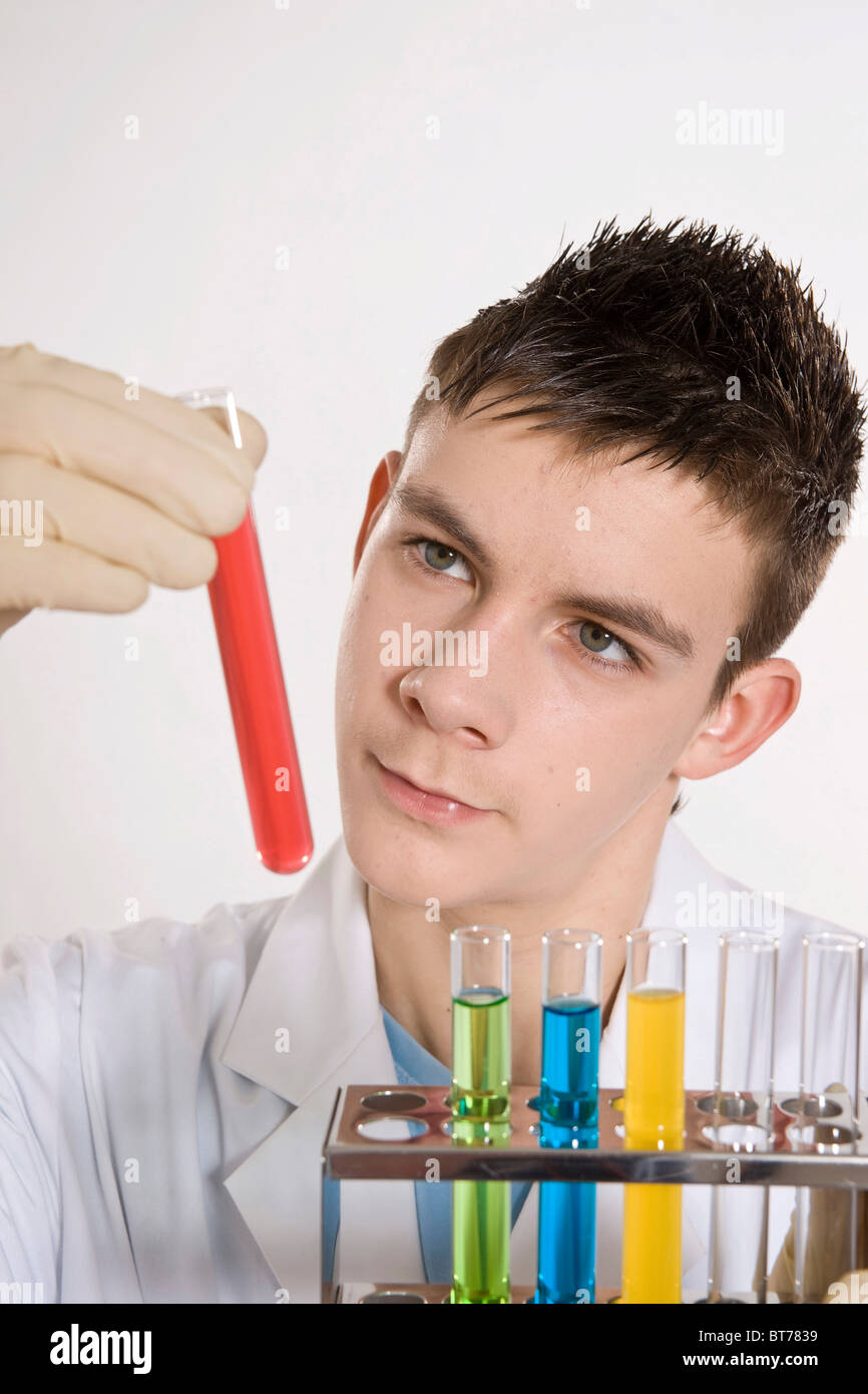 Teenage boy working in a laboratory, checking a test tube Stock Photo ...