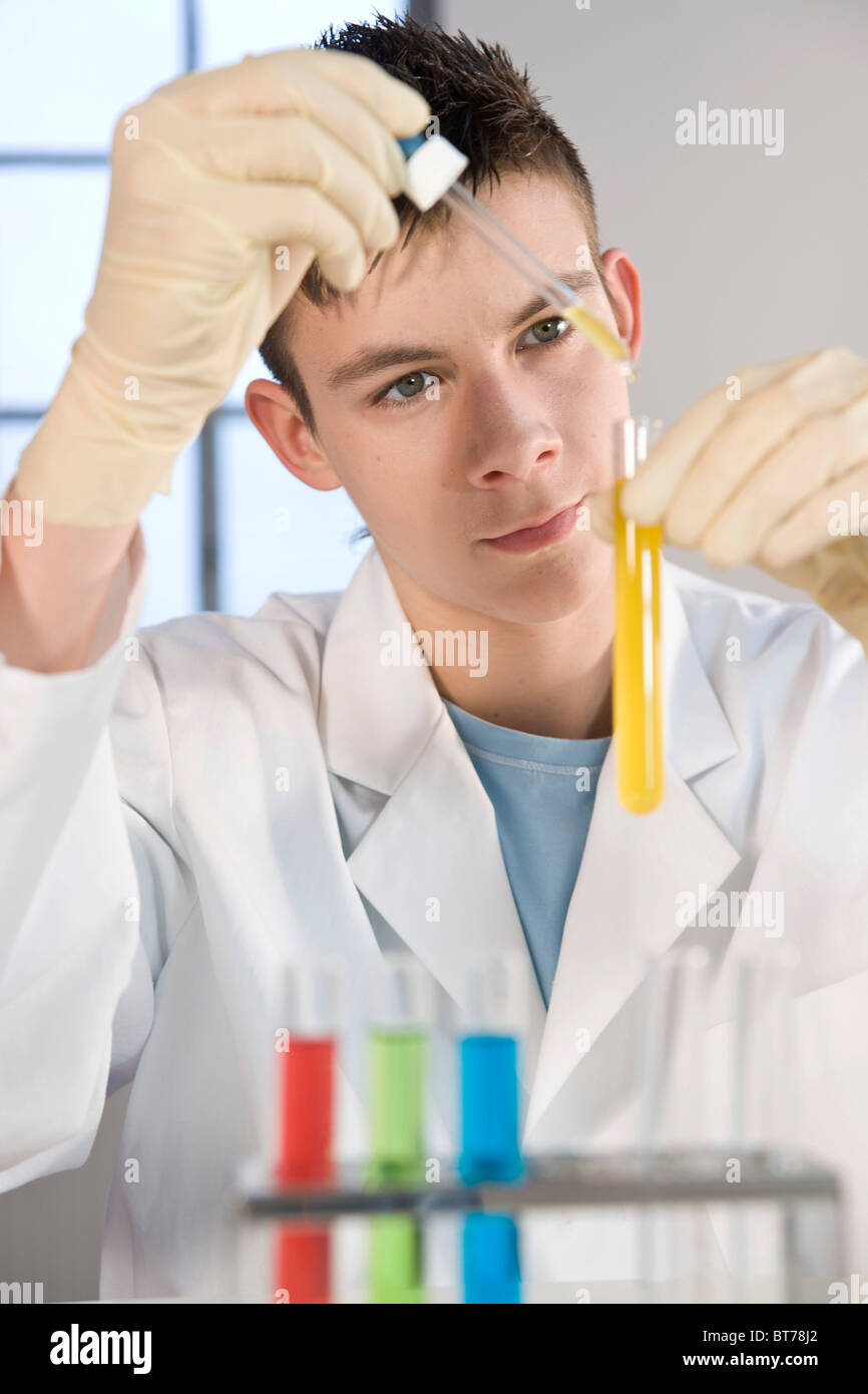 Teenage boy in a laboratory, working with test tubes Stock Photo - Alamy
