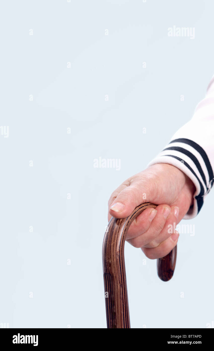 Vertical image of elderly human hand leaning on cane handle Stock Photo ...