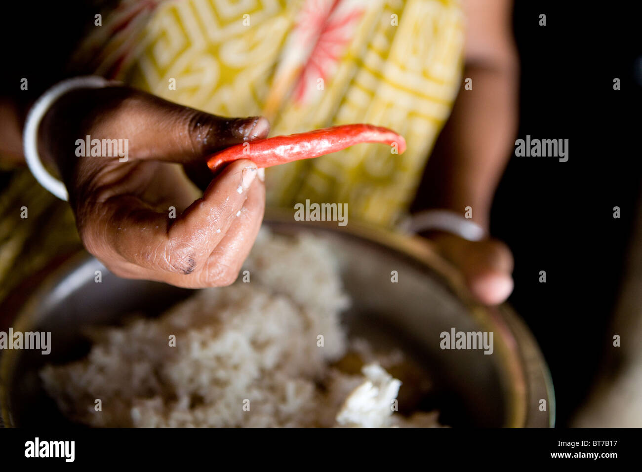 Indian woman preparing to cook with red chilli Stock Photo - Alamy