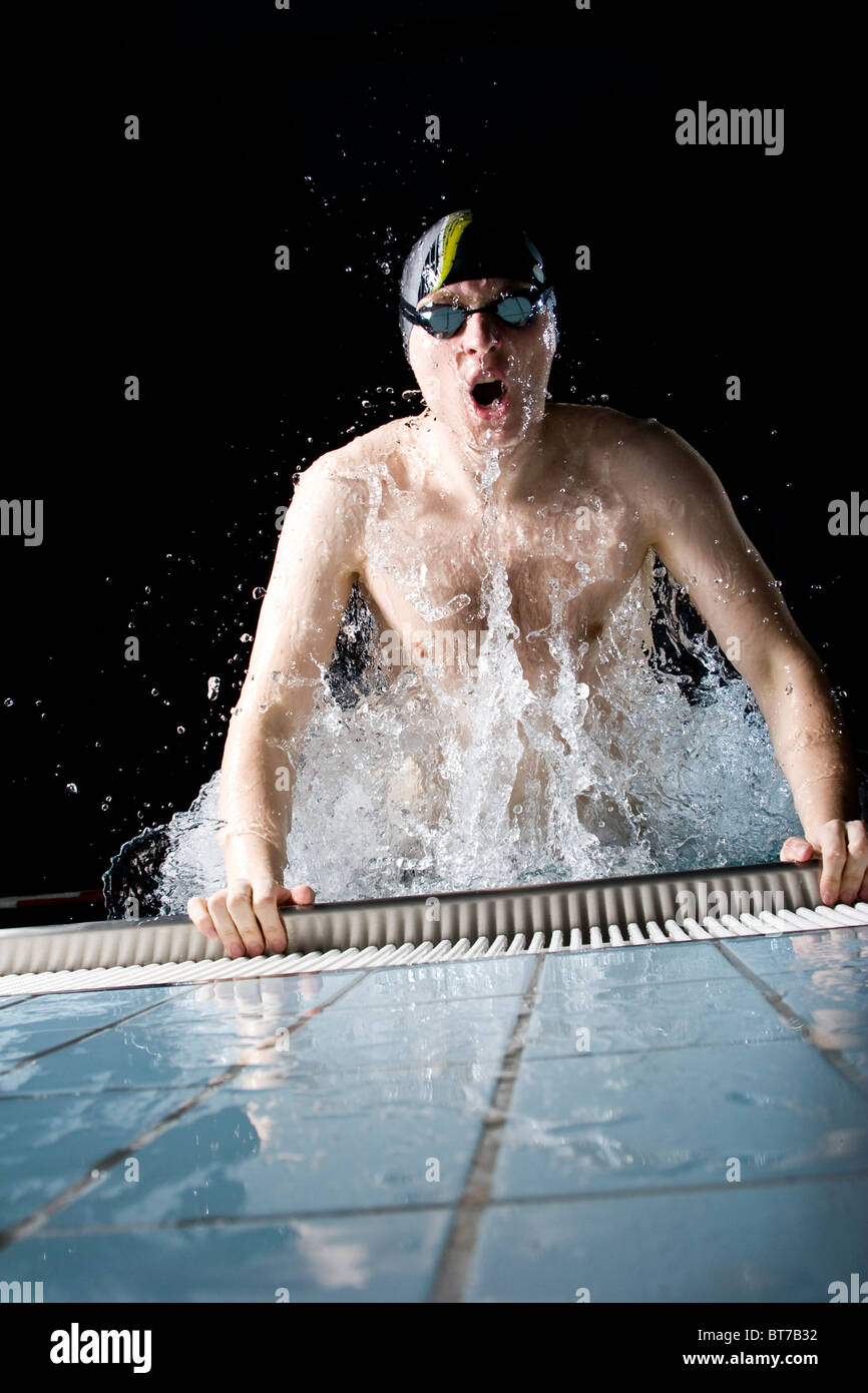 Swimmer jumping from water on balck background Stock Photo - Alamy