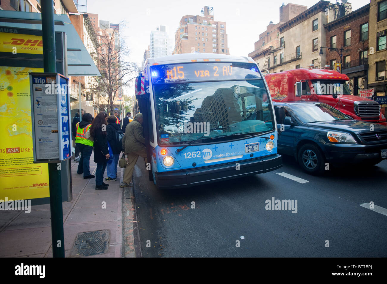 Commuters board a Select Bus Service bus on Second Avenue in Midtown in ...