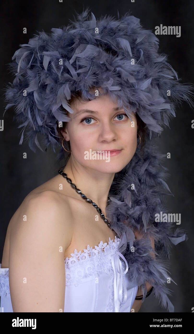 Portrait of the beautiful girl with a boa on a head Stock Photo - Alamy