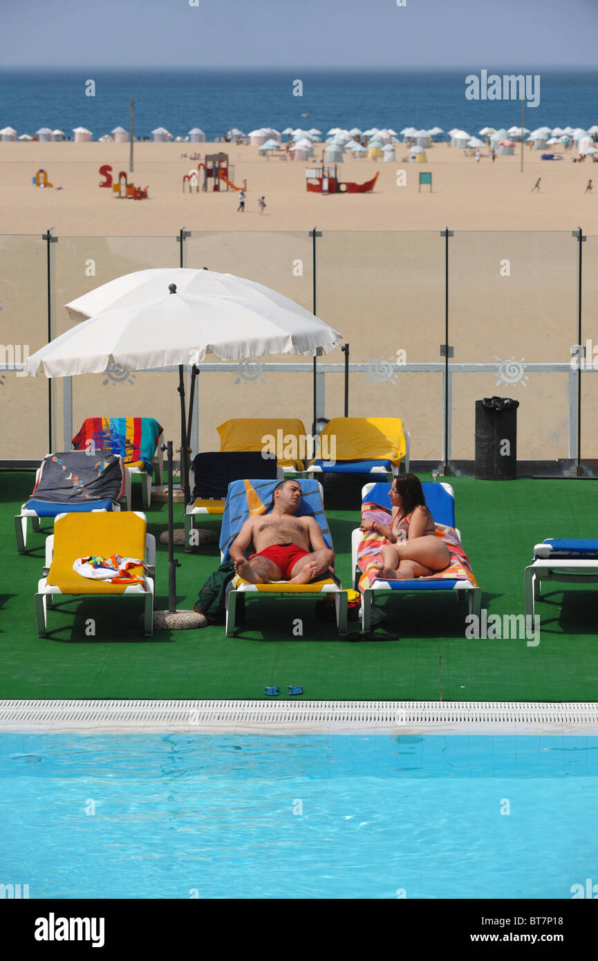 Couple sunbathing loungers hi-res stock photography and images - Alamy