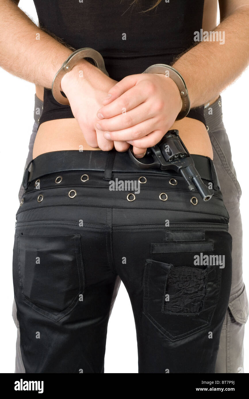 The criminal couple. Handcuffs, pistol. Rear view. Isolated Stock Photo ...