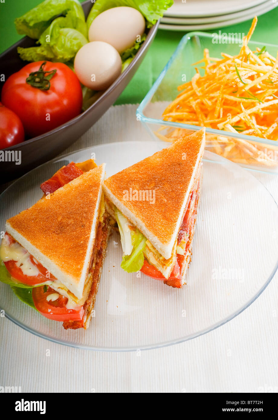 fresh and delicious classic club sandwich over a transparent glass dish ...