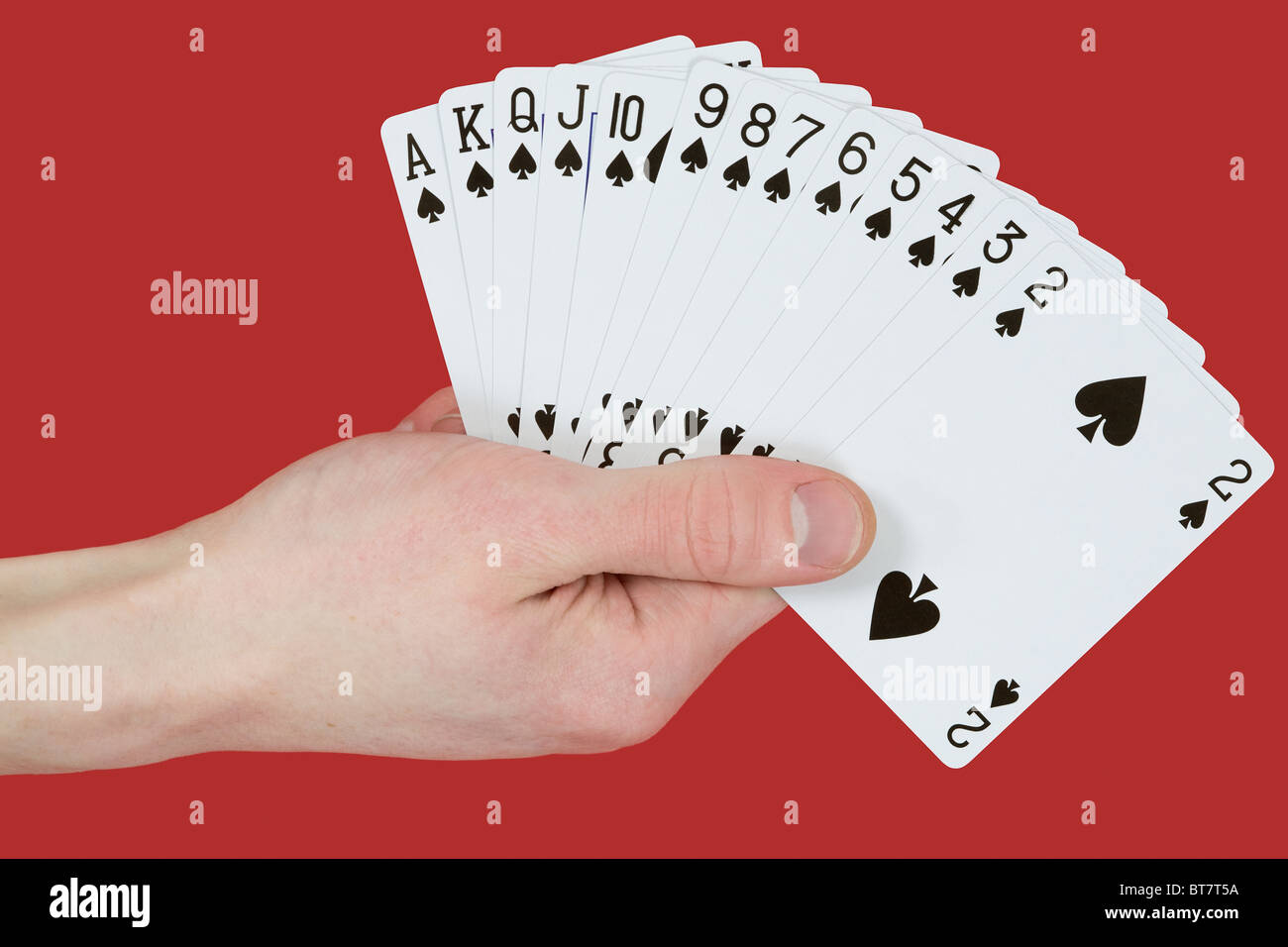 Playing cards on hands on the red background Stock Photo - Alamy