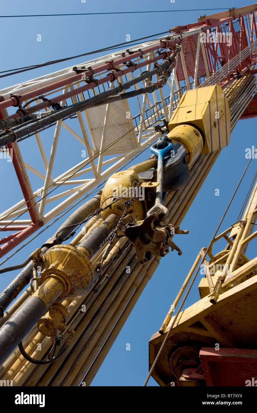 Onshore oil and gas exploration site. View to top of derrick with ...