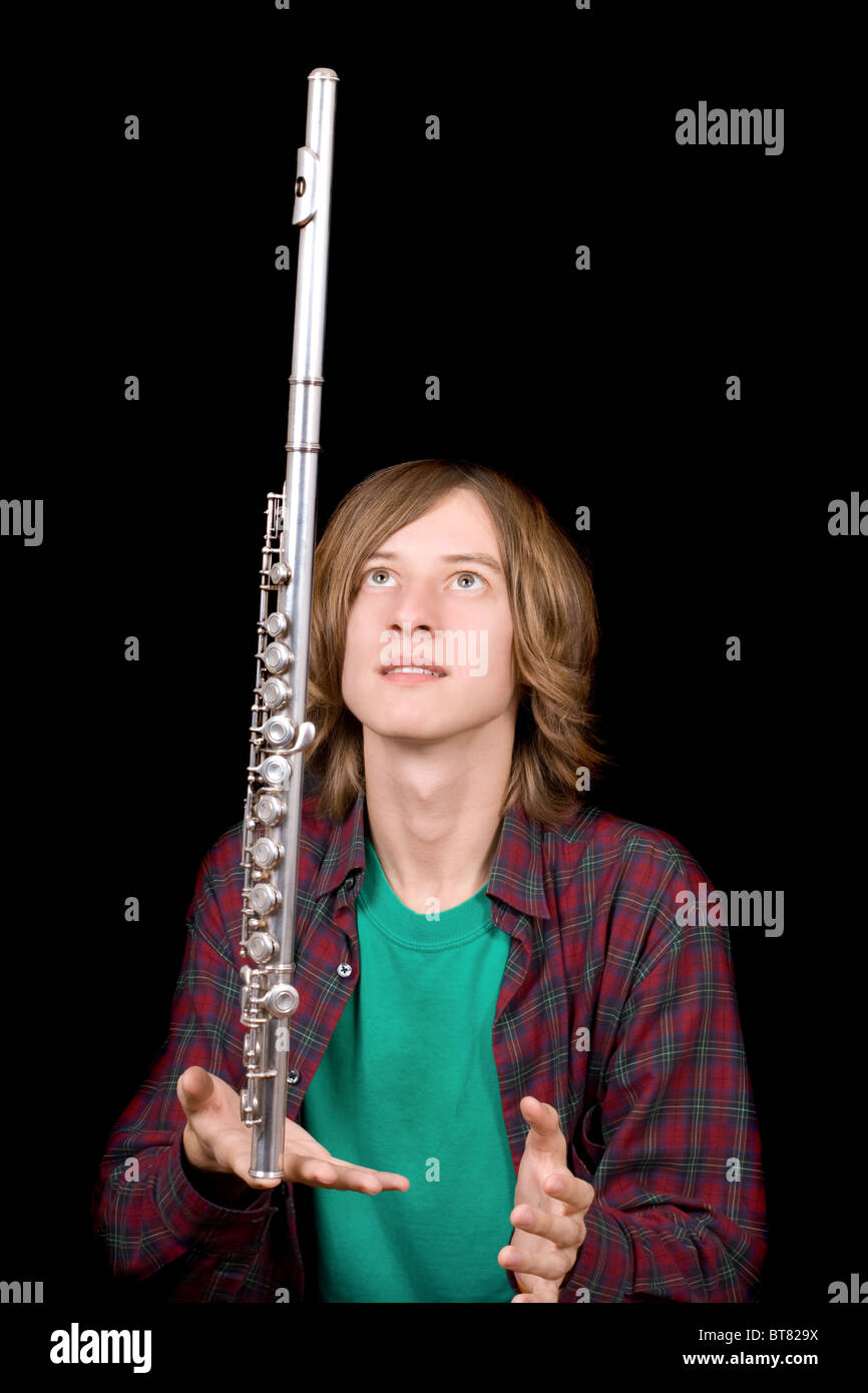 The young man plays with a flute Stock Photo - Alamy
