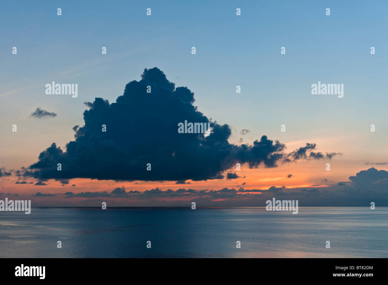 View of Calm Seas and Distant Clouds at Sunset from the Deck of a ...
