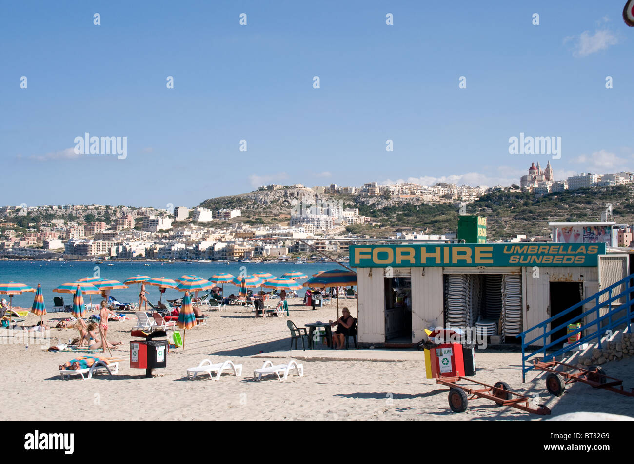 Sunworshipers enjoy the sandy beach and the clear shallow water at ...