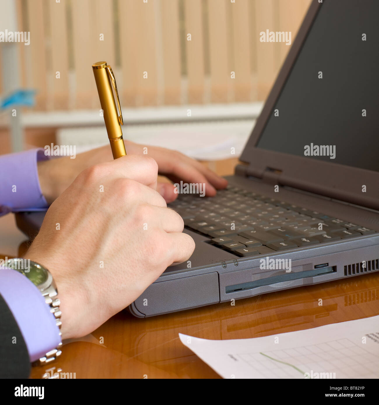 The laptop and man's hands with a pen Stock Photo - Alamy