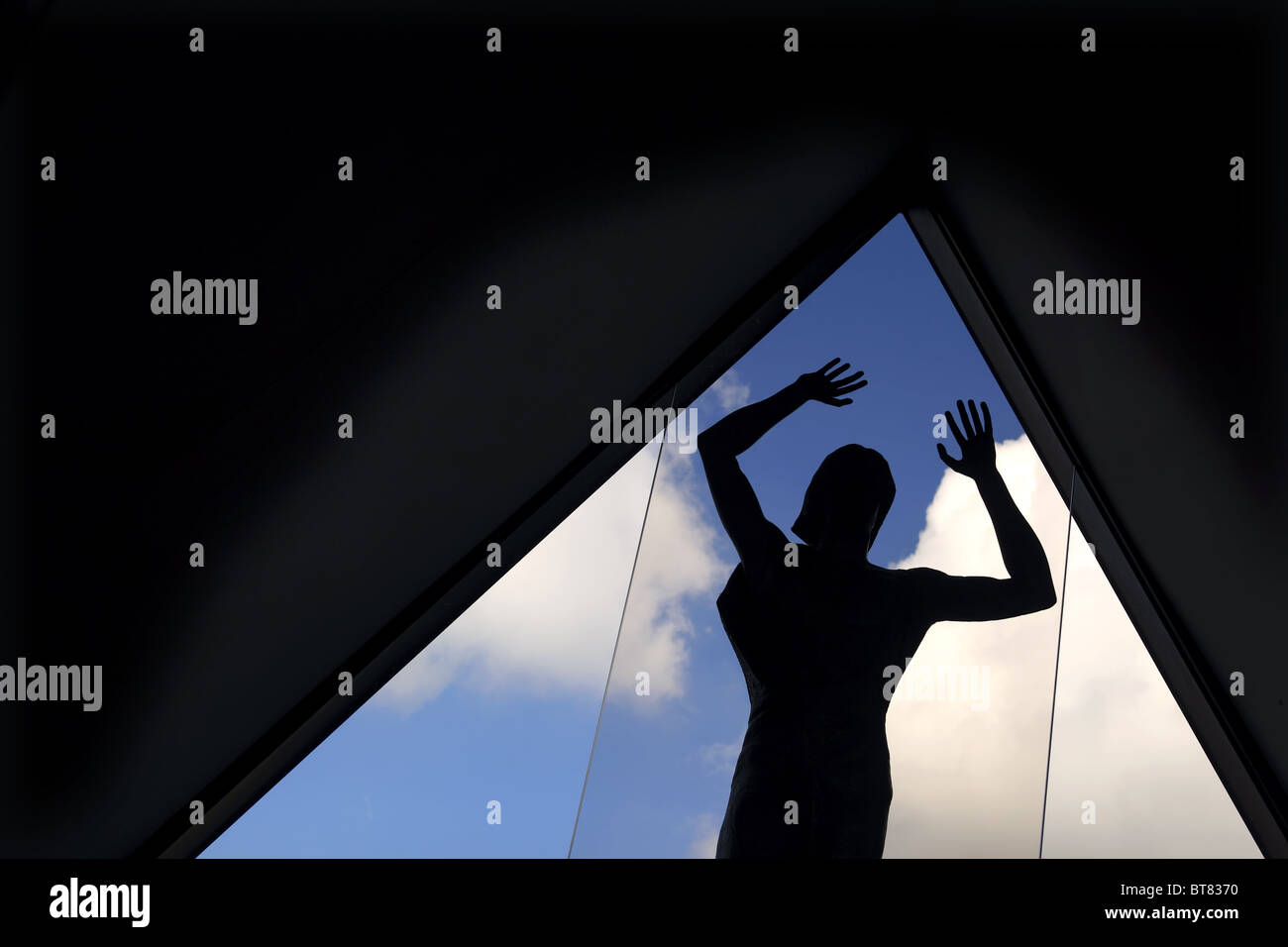 Silhouette of statue reaching up Stock Photo - Alamy