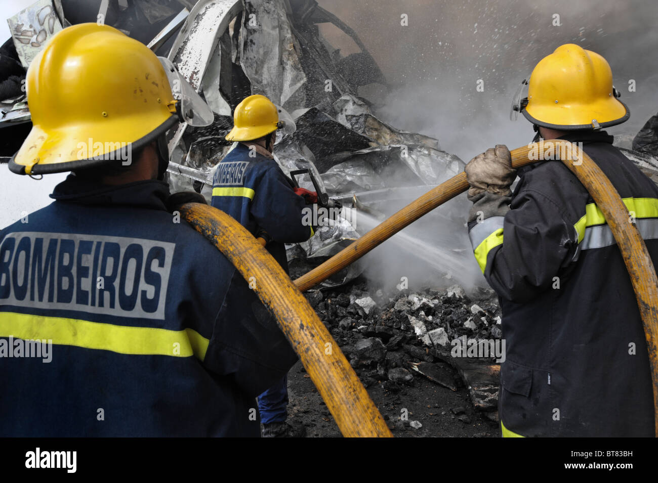 Firefighter putting out fire with hose hi-res stock photography and ...
