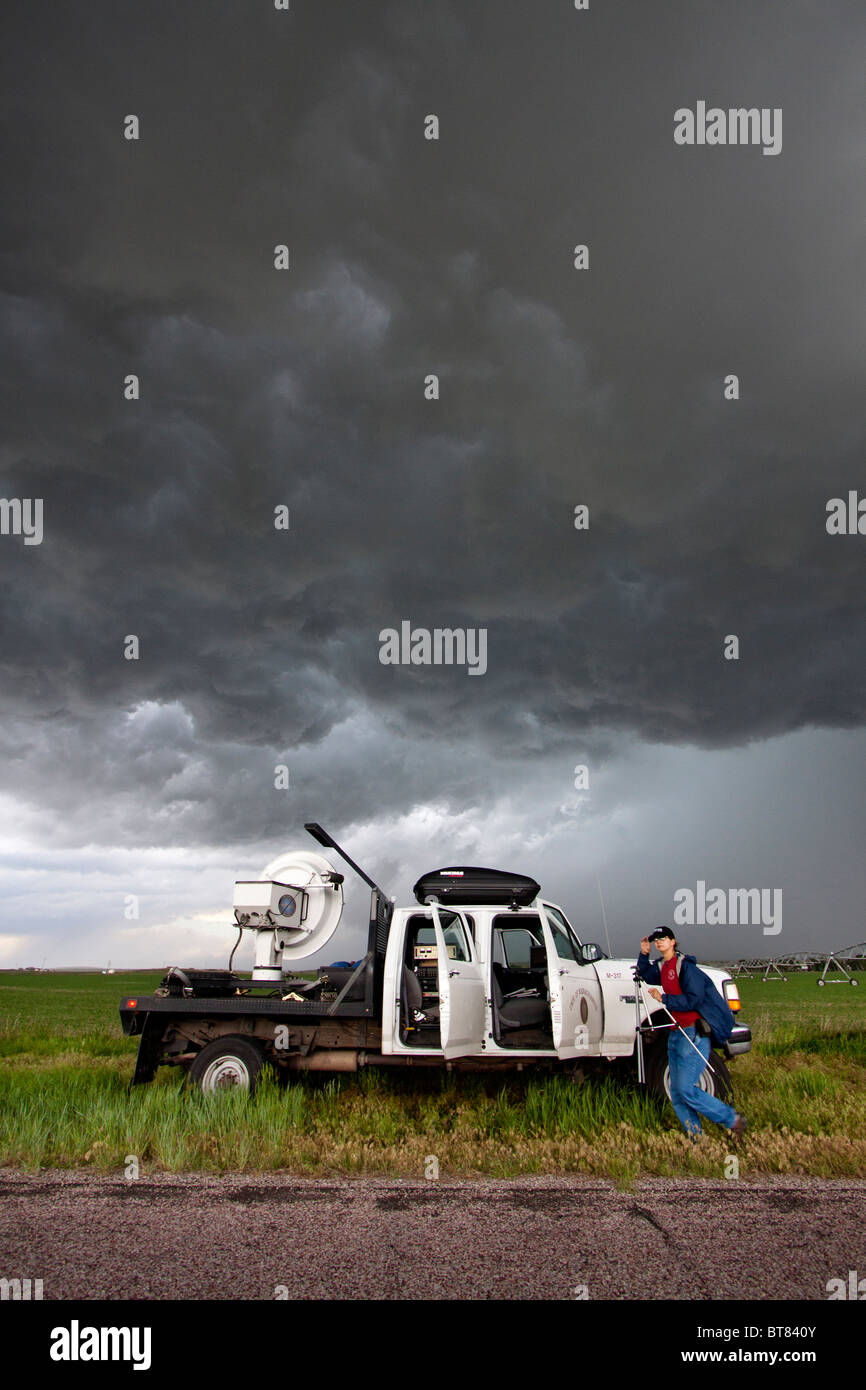 Storm chaser and scientist Robin Tanamachi stands next to a doppler ...