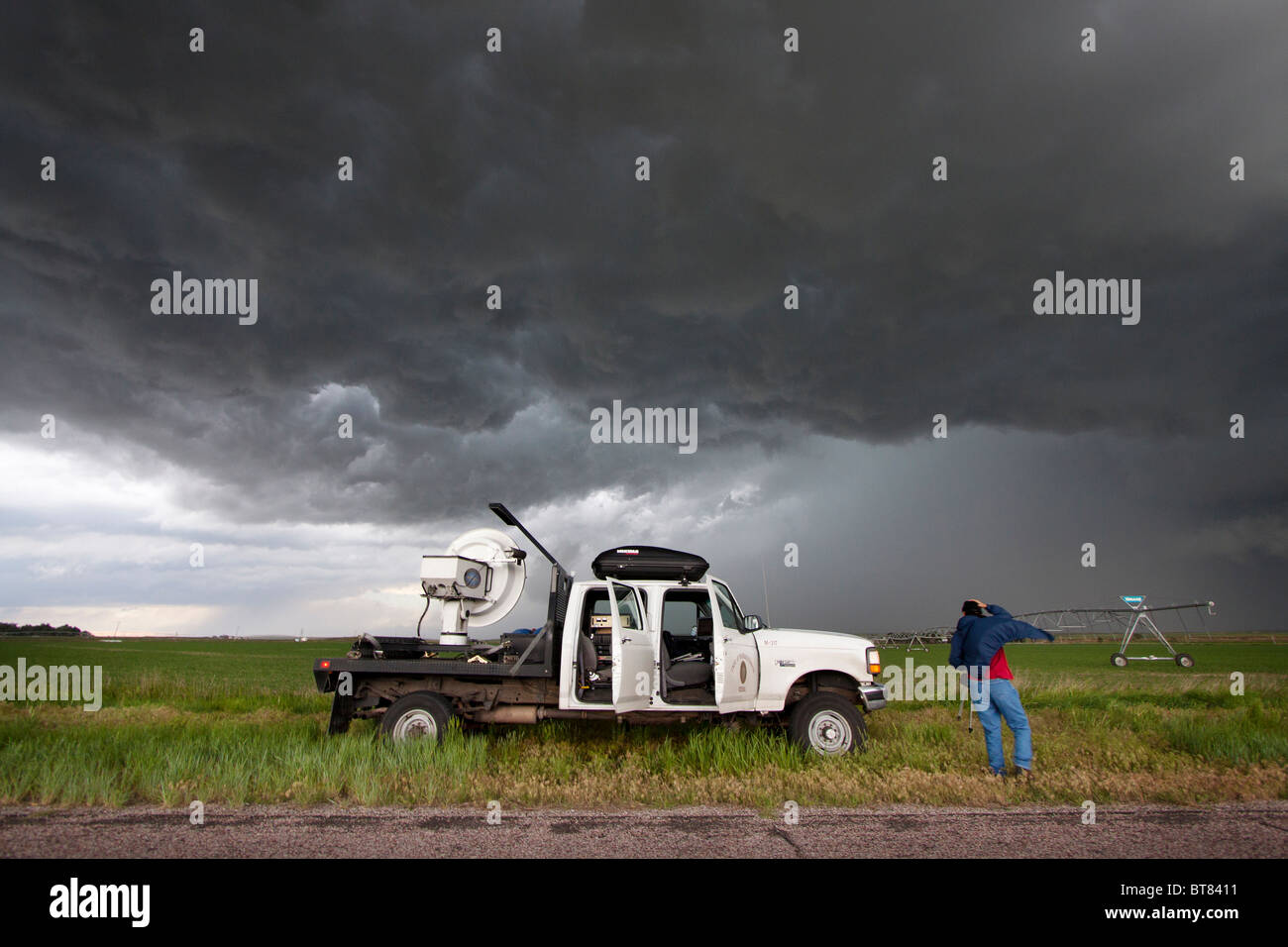 Storm chaser and scientist Robin Tanamachi stands next to a doppler ...