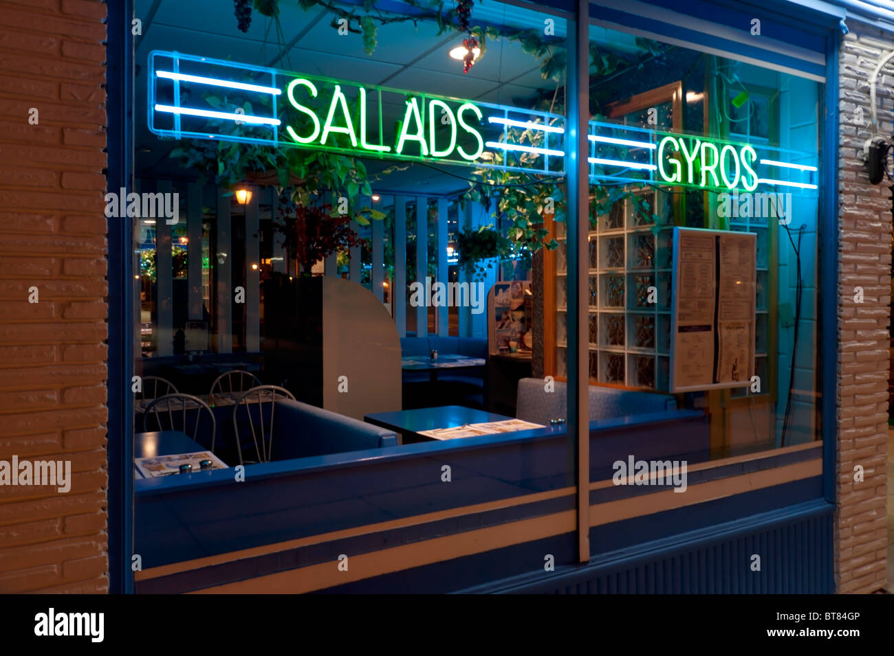 Seen through exterior window with neon signs, Greek Restaurant closed ...