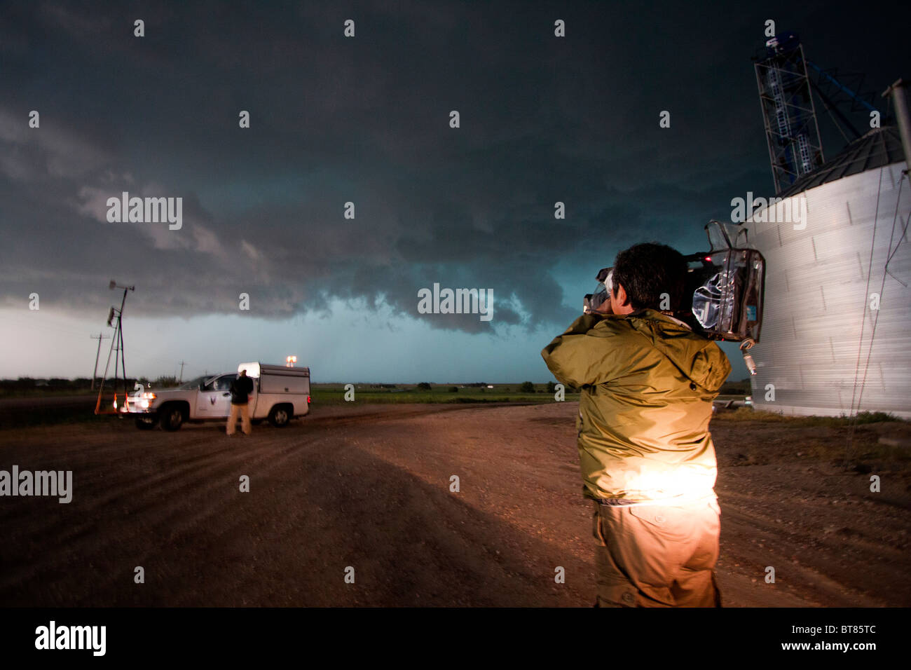 A videographer with Japan's NPK television service records storm ...